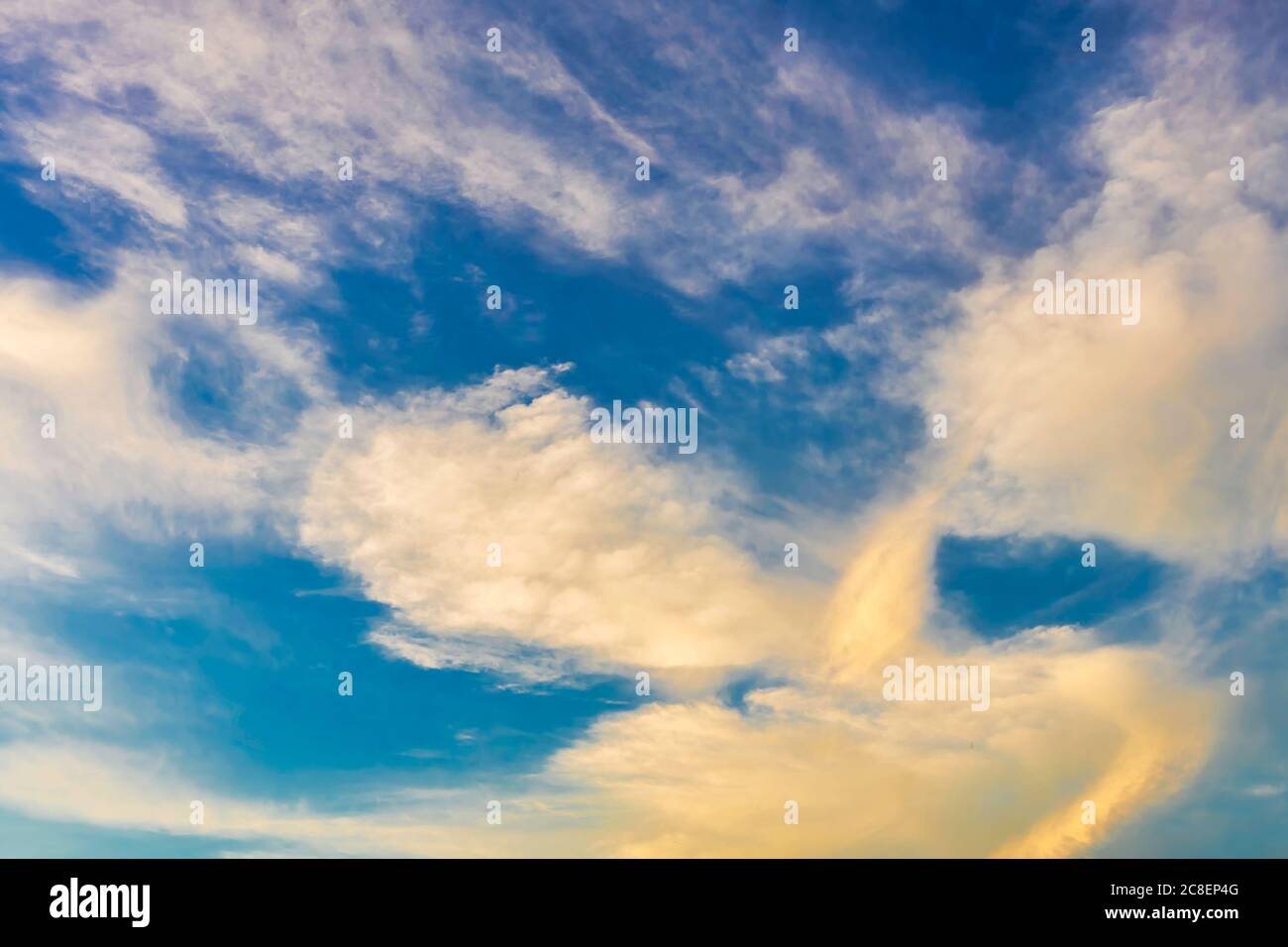 Blue sky with yellow fluffy clouds in the morning Stock Photo - Alamy