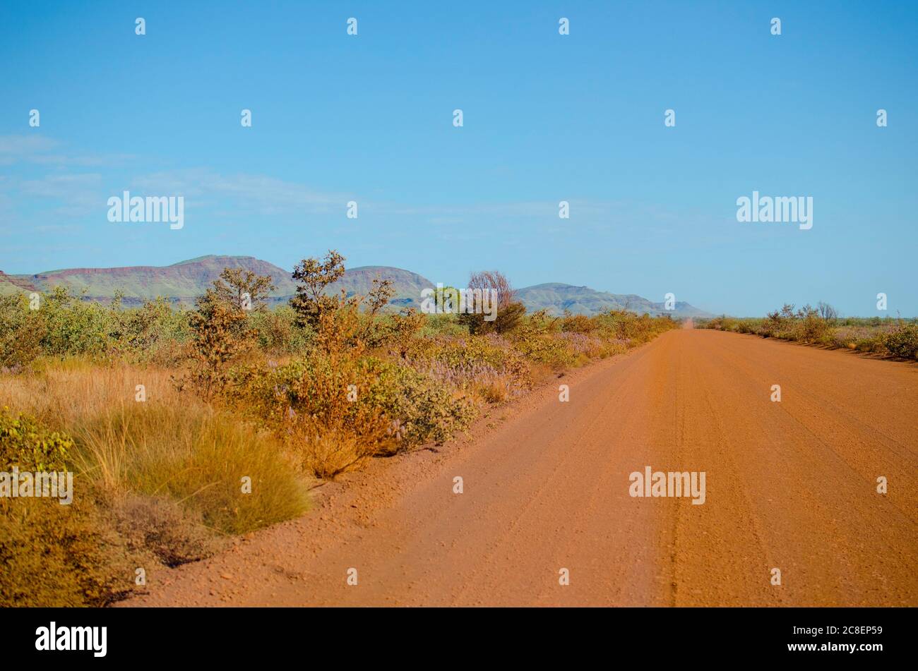 Dirt gravel road in remote outback Australia, with mountain range of ...
