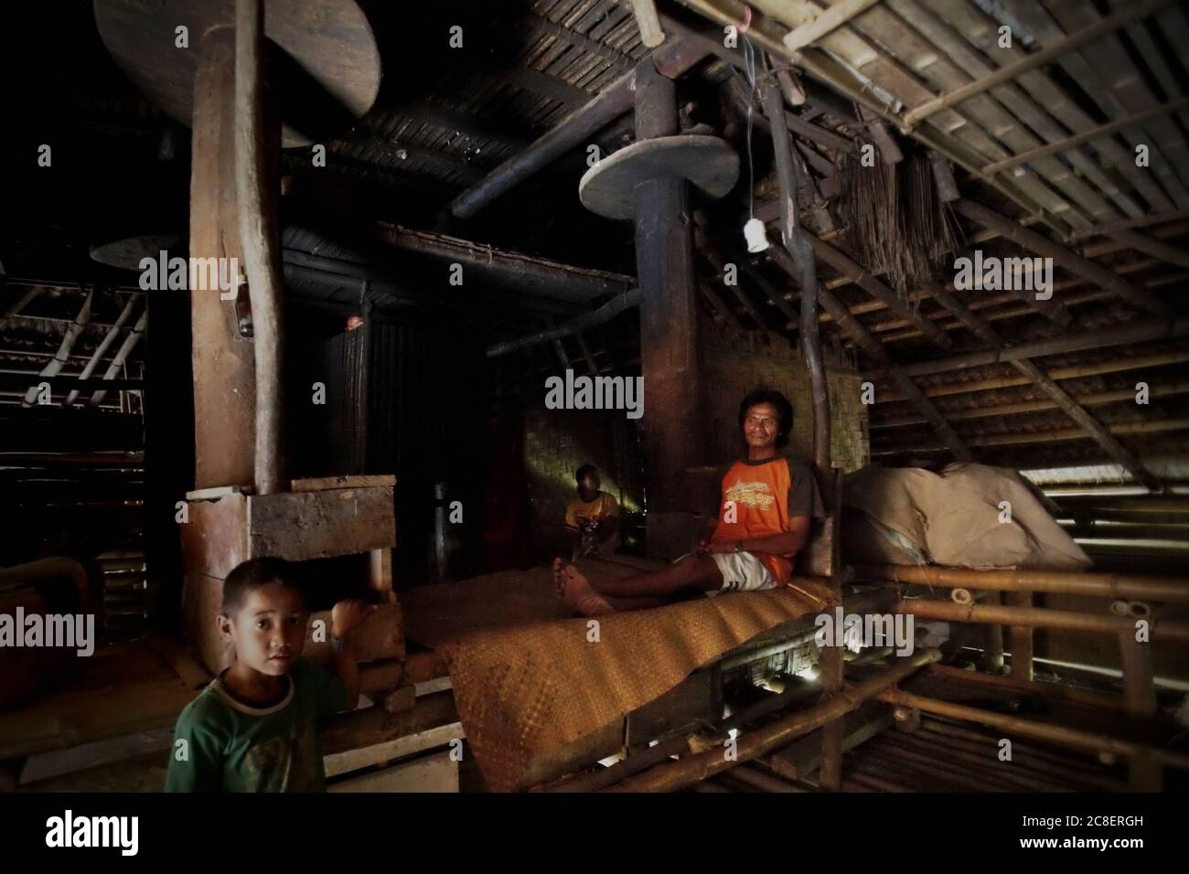 Portrait of a Sumbanese family inside their traditional house in Tebara ...