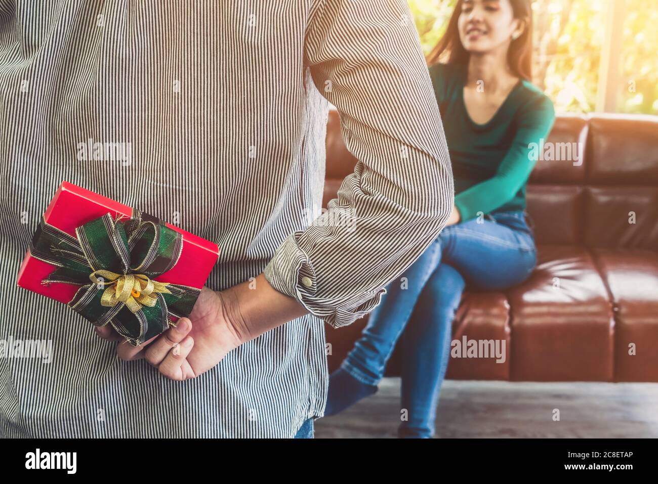 Happy couple giving gift present to celebrate Stock Photo - Alamy