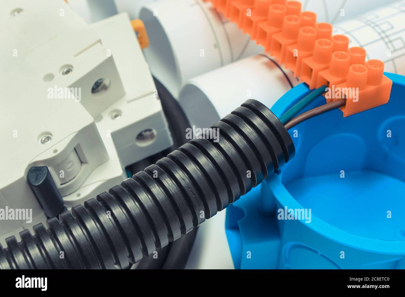 Plastic orange electrical cube with connections of electric copper ...