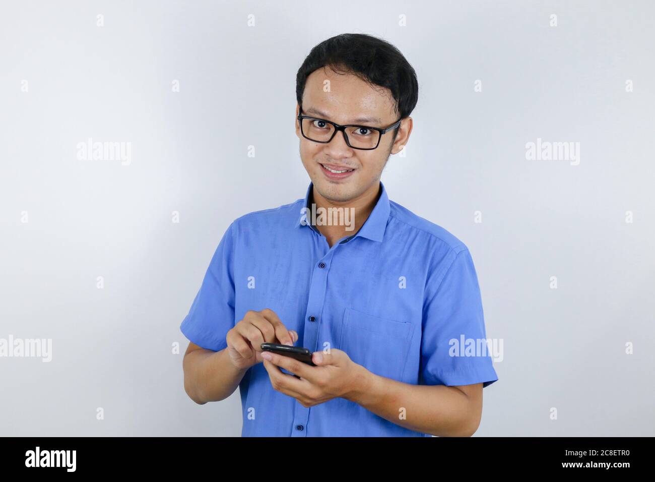 Smile and happy face of Young Asian man with phone in hand. Advertising ...