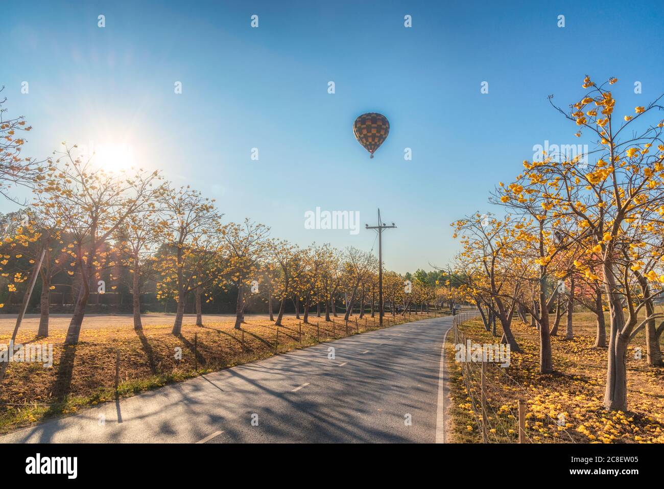 The scenery of the lonely hot air balloon flying over the road that on ...