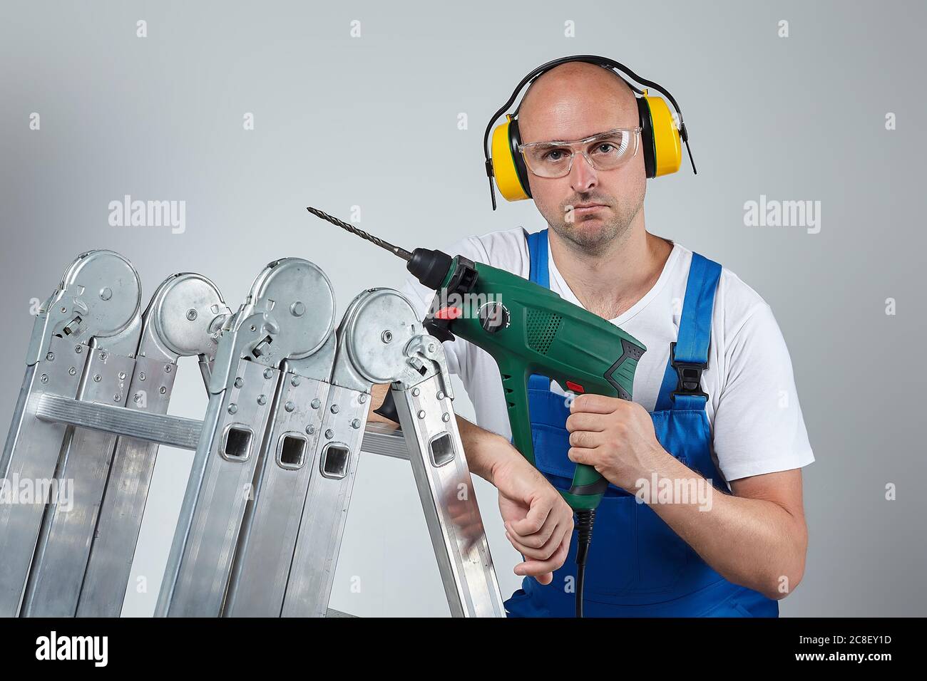 grown man with a drill in his hands . photo session in the Studio on a ...
