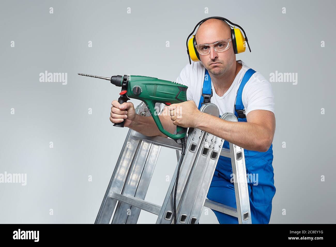 grown man with a drill in his hands . photo session in the Studio on a ...