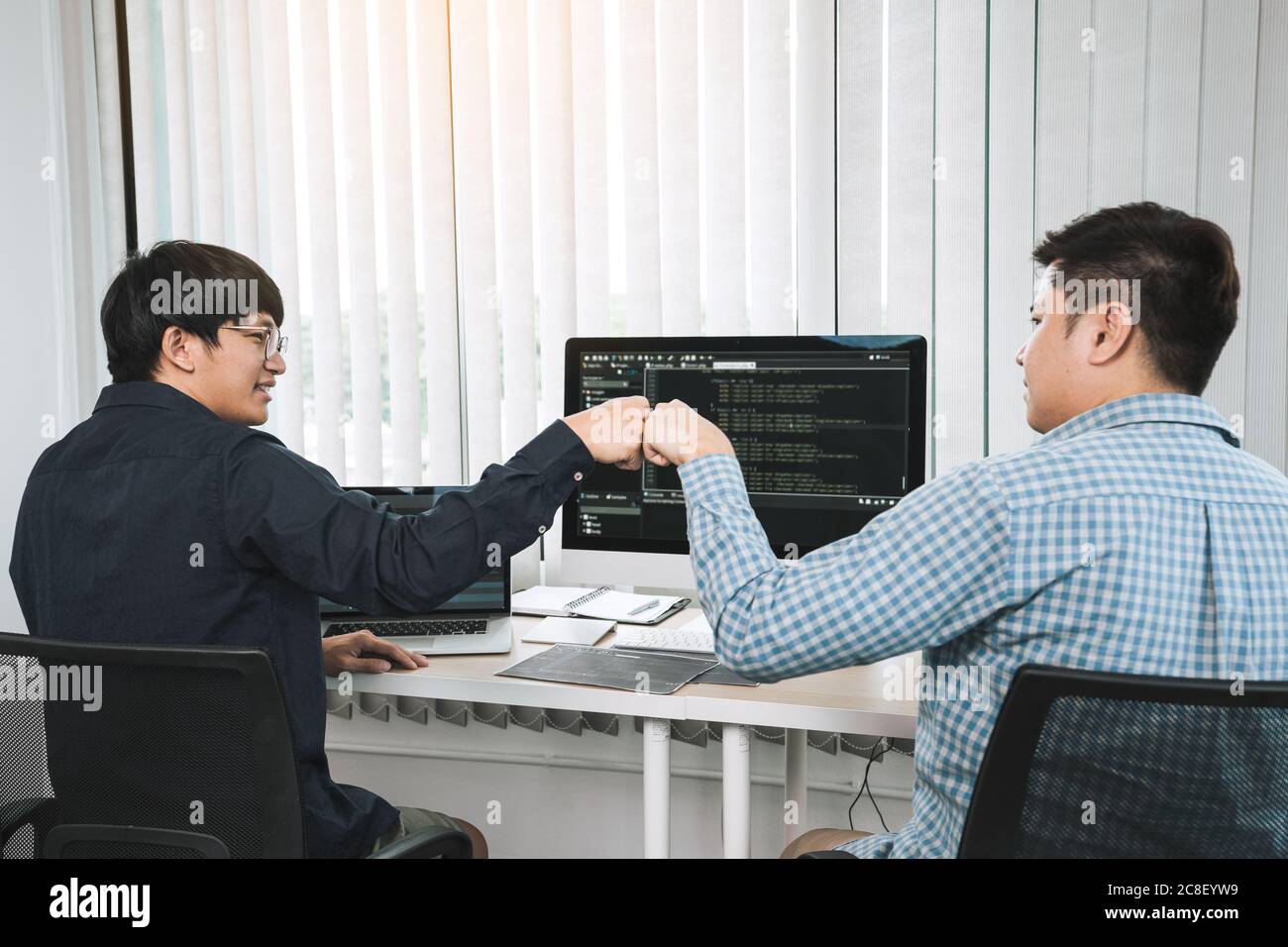 Asian employee software developers celebrate success project by fist ...