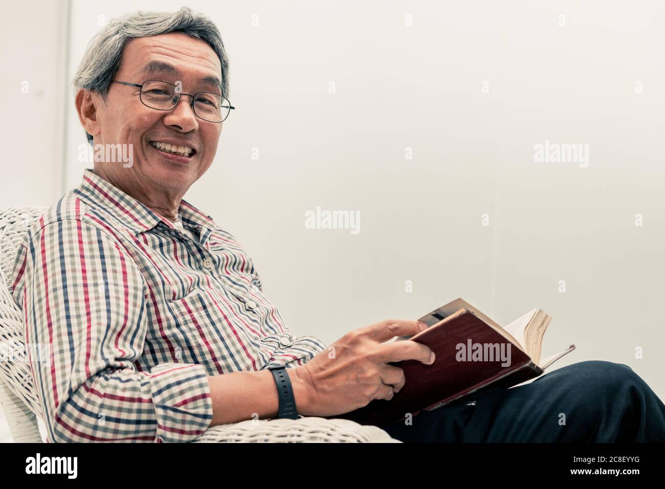 Man with book on chair hi-res stock photography and images - Alamy