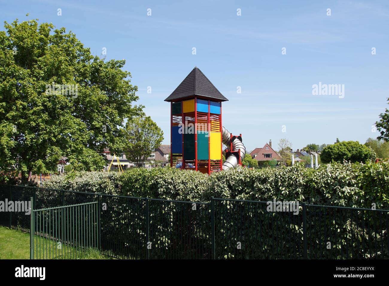 Dutch playground in Holland. A colorful climbing tower and slide behind ...
