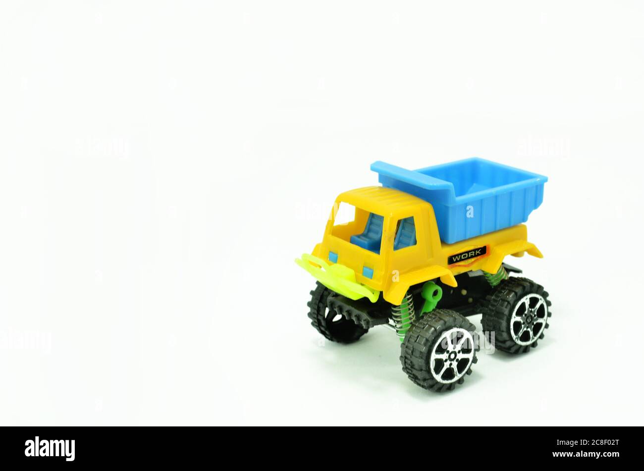 Plastic dump truck toy isolated on white background Stock Photo - Alamy