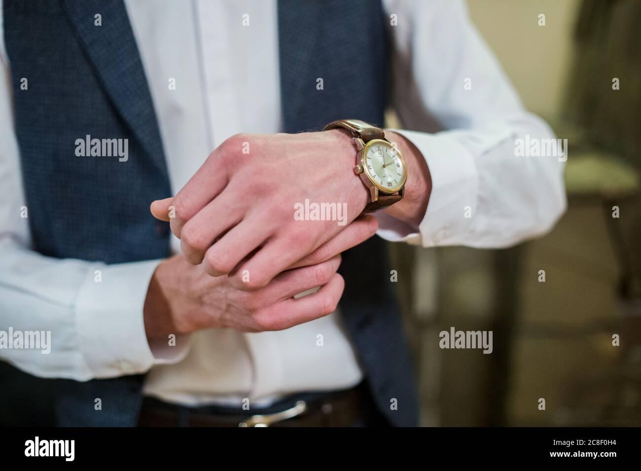 a man put watch on his hand Stock Photo - Alamy