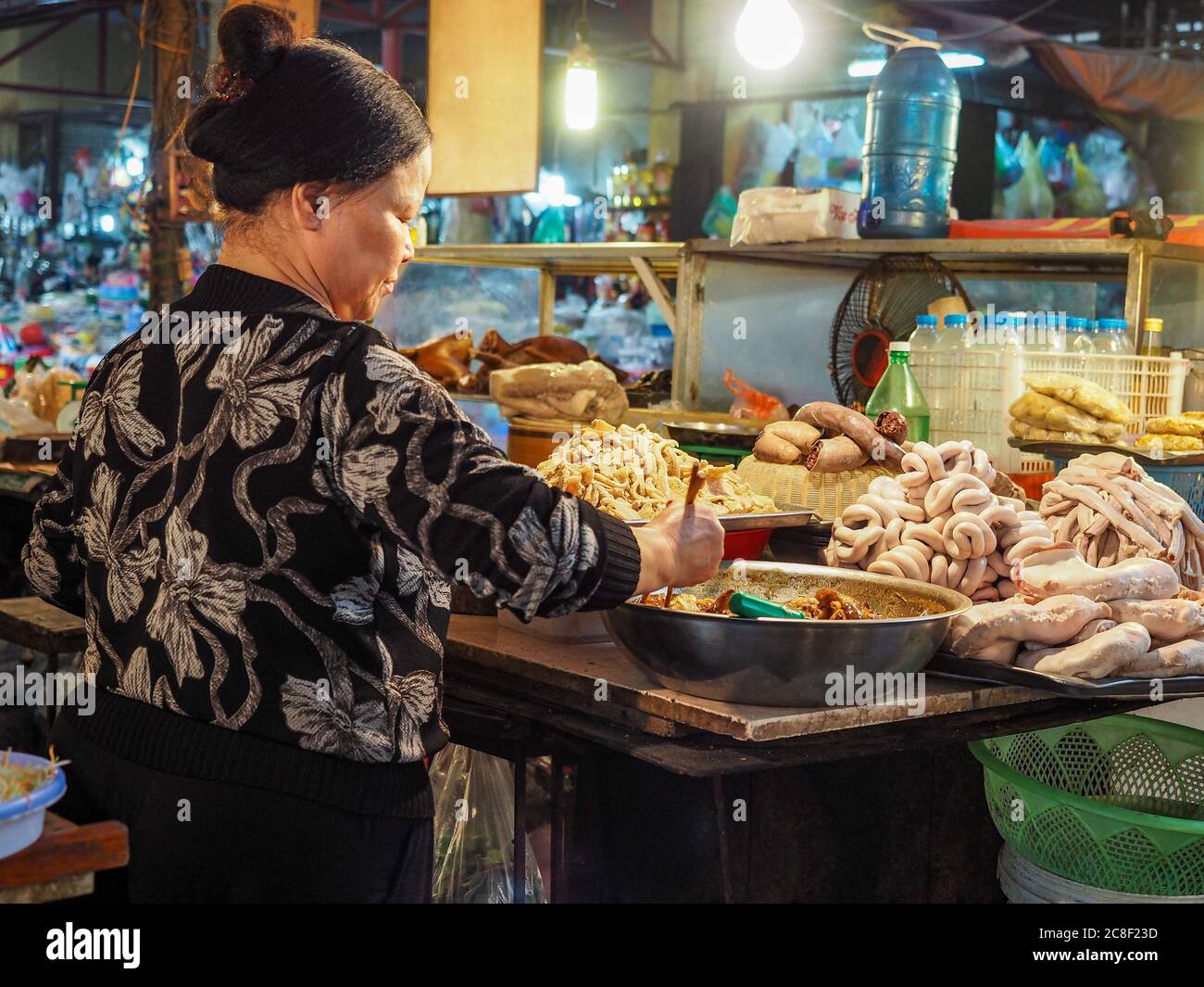 Woman selling meat and viscera in Hanoi market. Vietnam. March 16, 2017 ...