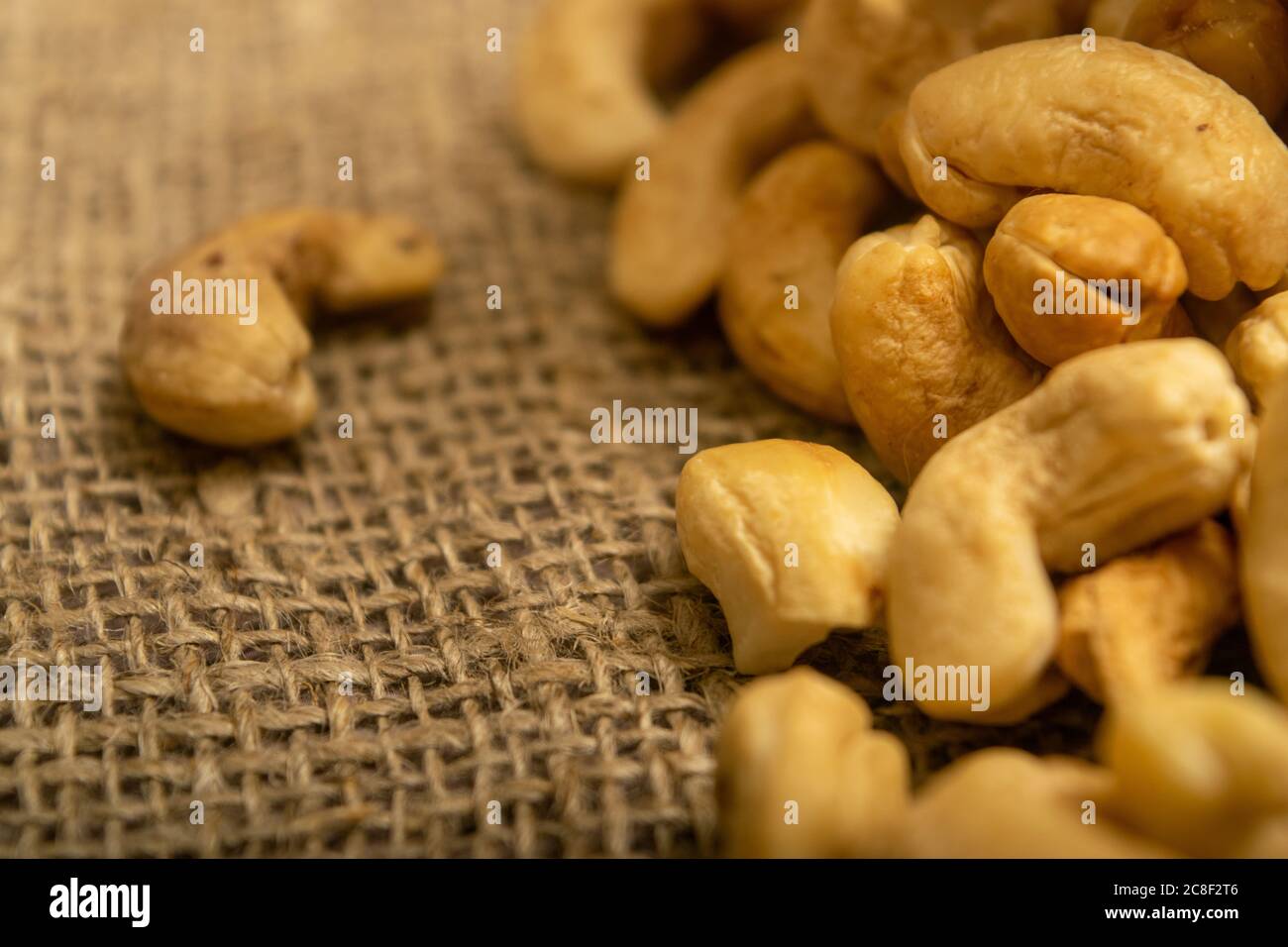 A pile of cashew nuts on burlap with a rough texture surface texture ...