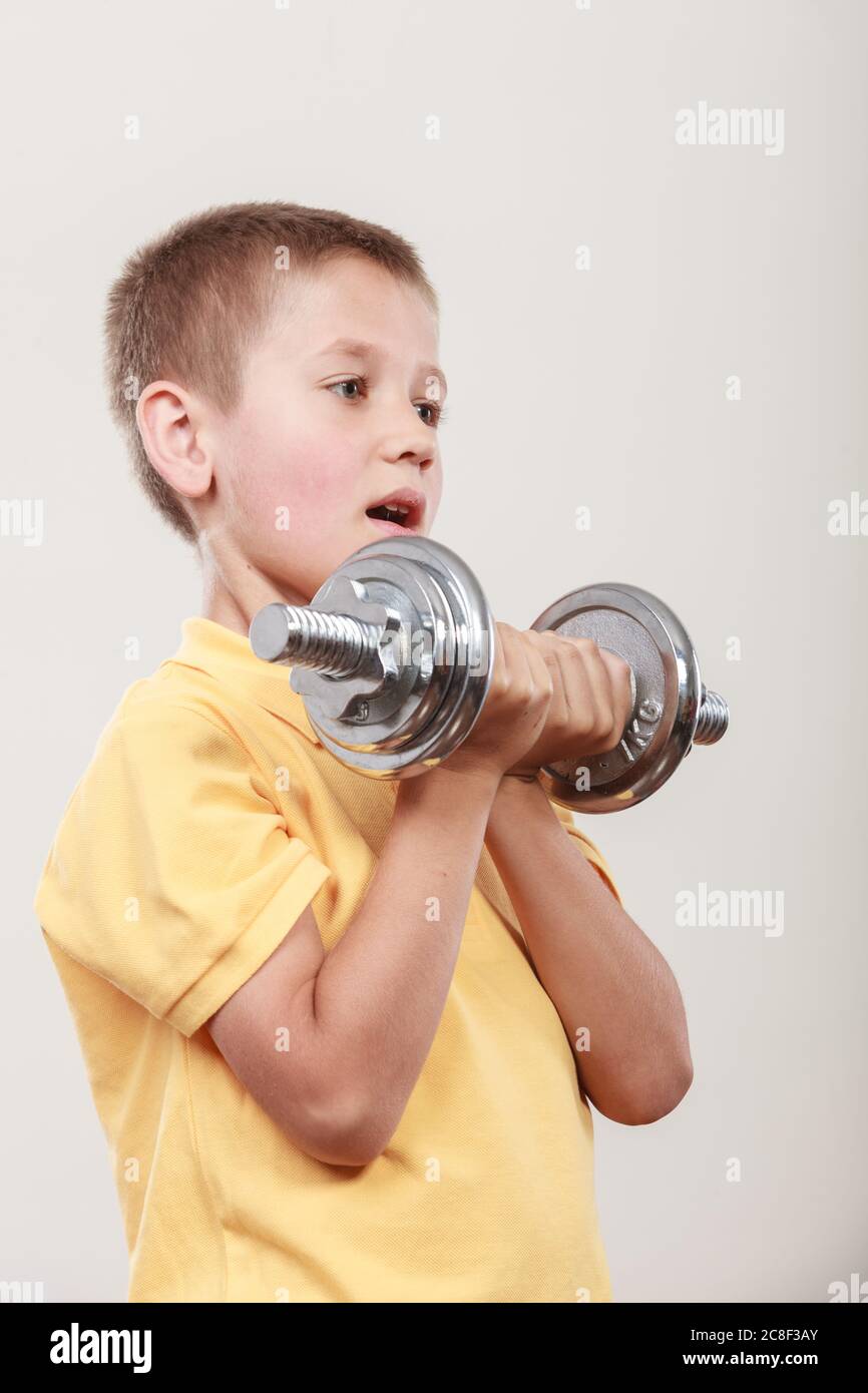 Sports boy making exercise with dumbbell. Care about health and body ...