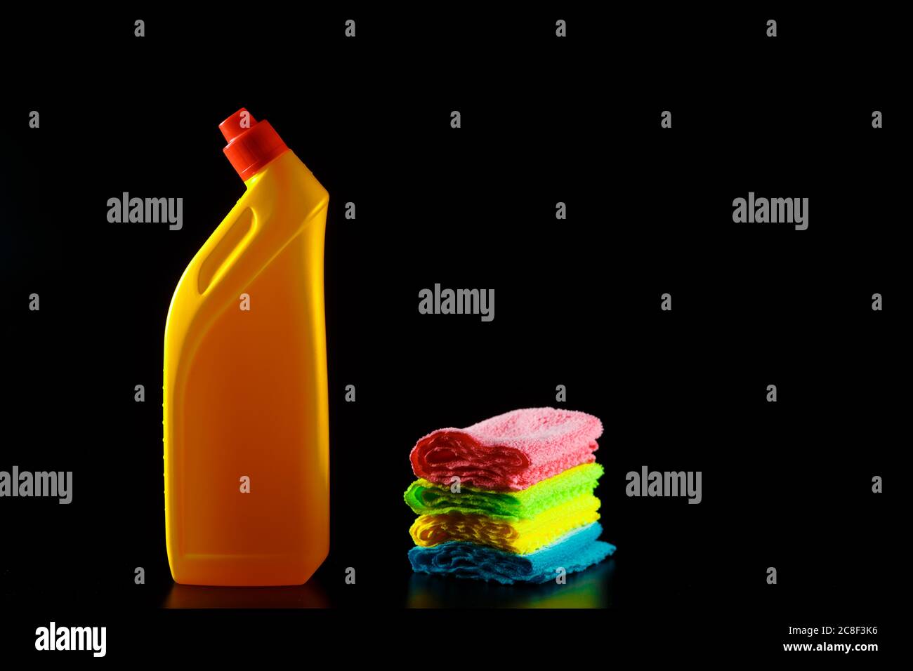 yellow toilet cleaner with rags on a black background Stock Photo - Alamy