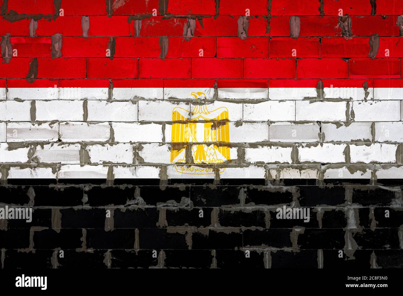 The national flag of Egypt painted on a wall of sibit blocks with ...