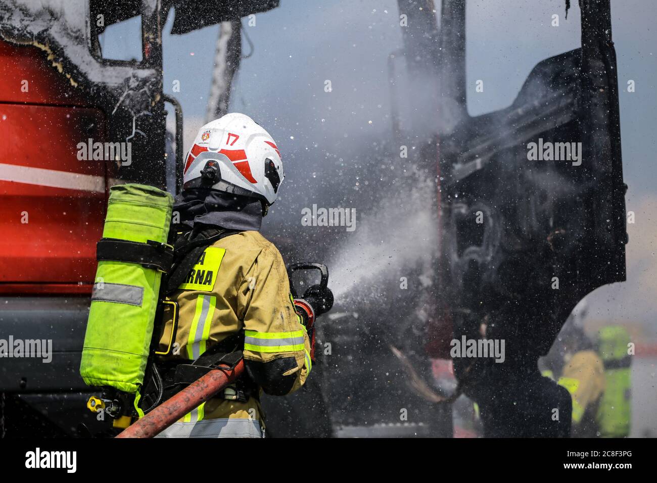 a firefighter in heavy equipment seen while putting out the fire in a ...