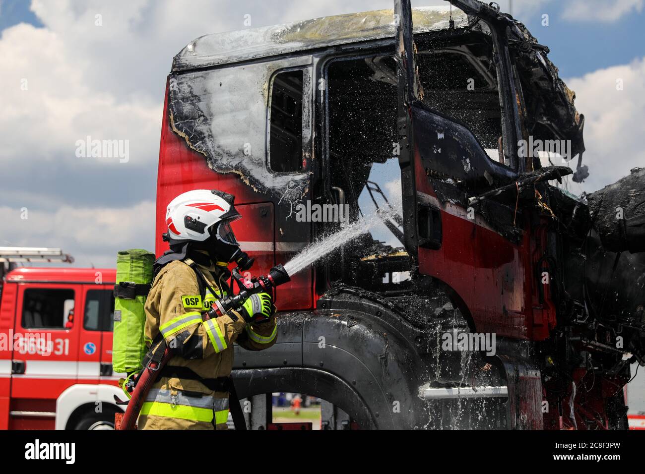 a firefighter in heavy equipment seen while putting out the fire in a ...