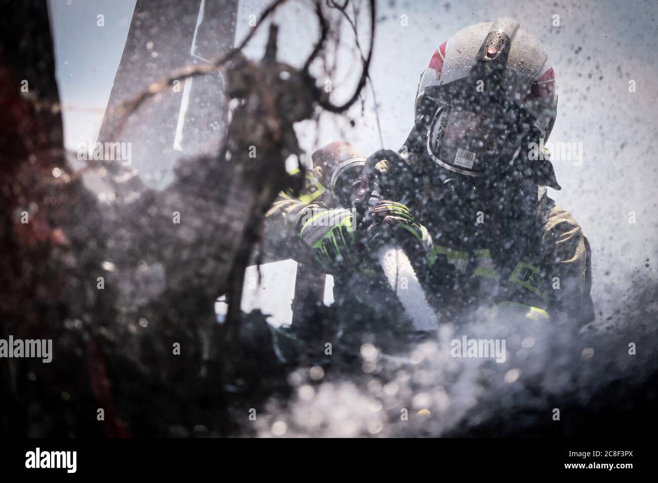 a firefighter in heavy equipment seen while putting out the fire in a ...