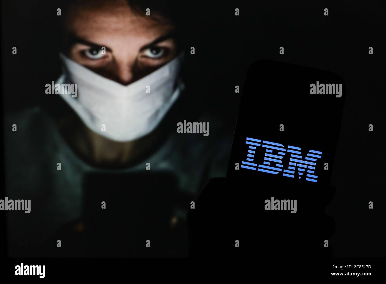 In this photo illustration an IBM company logo seen displayed on a ...