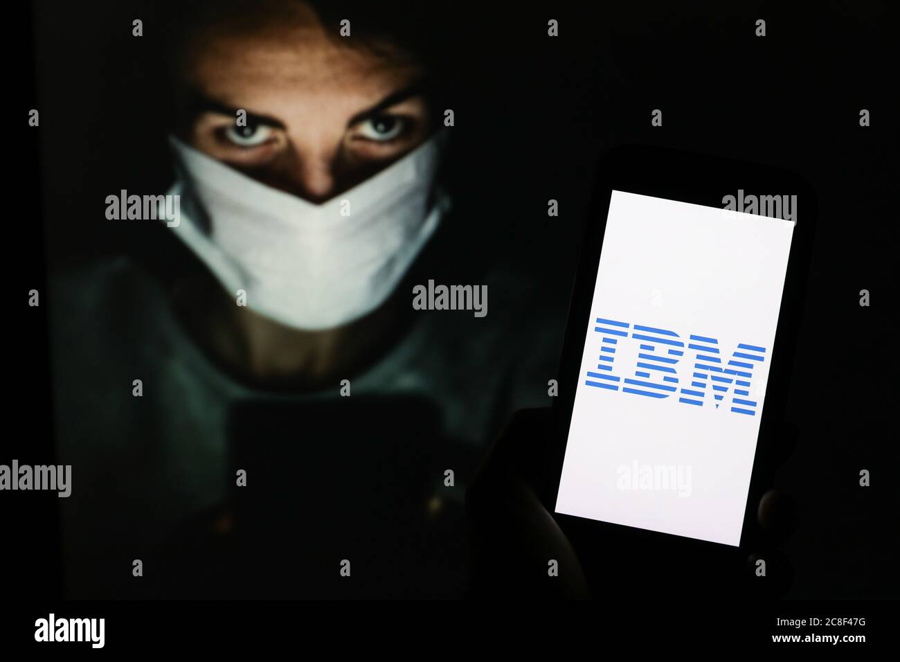 In this photo illustration an IBM company logo seen displayed on a ...