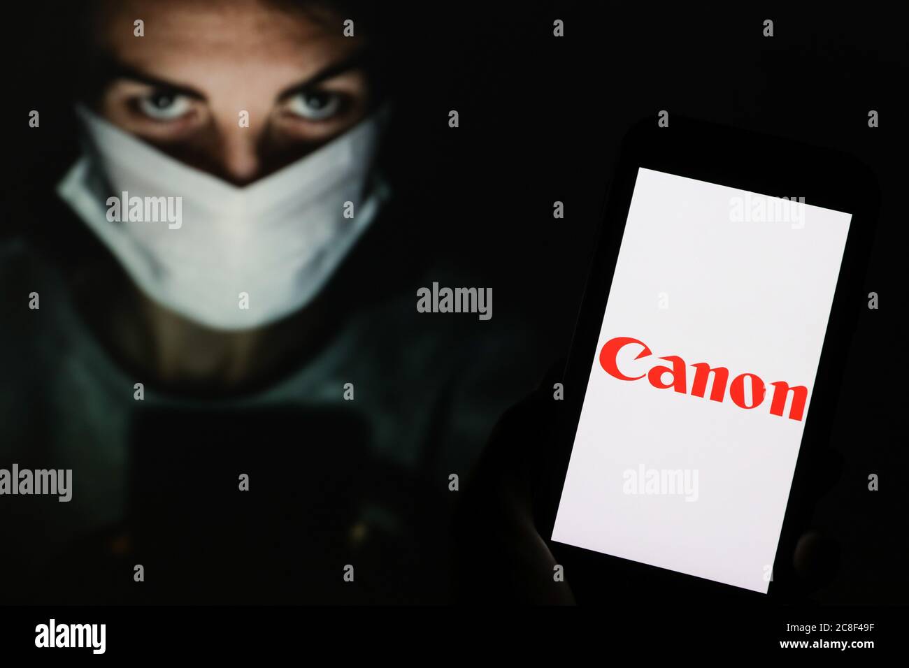 In this photo illustration a Canon logo seen displayed on a smartphone ...
