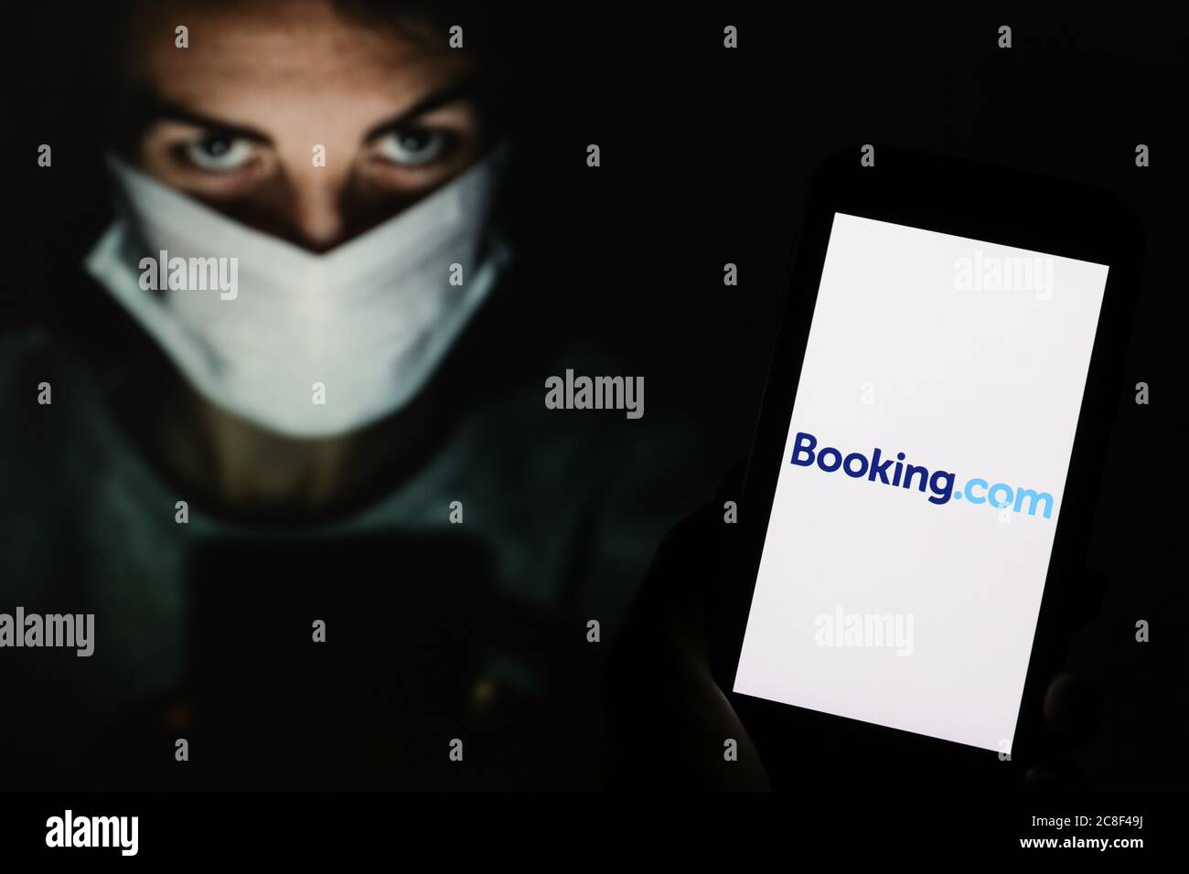 In this photo illustration a Booking.com logo seen displayed on a ...