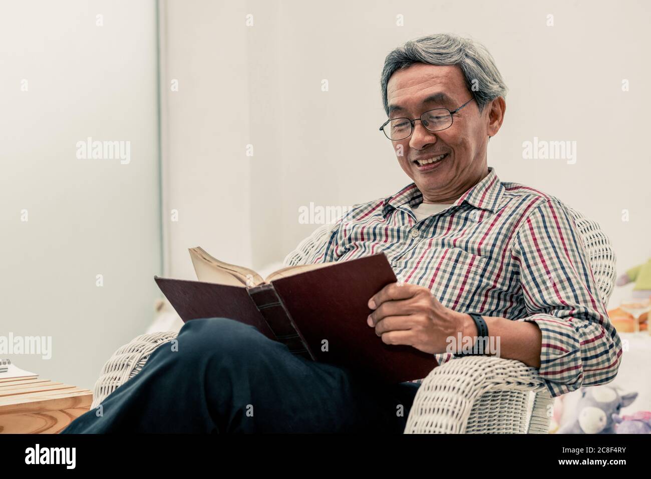 Man with book on chair hi-res stock photography and images - Alamy