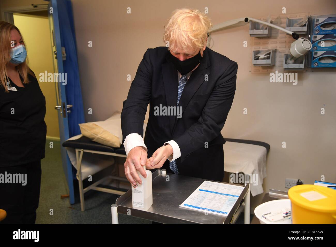 Prime Minister Boris Johnson uses hand gel during a visit to Tollgate ...