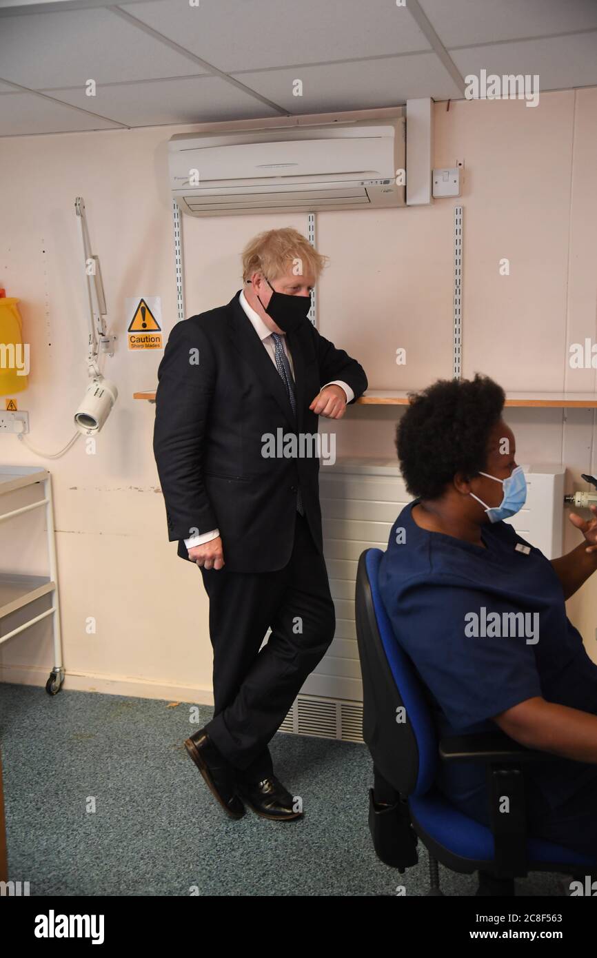 Prime Minister Boris Johnson speaks with staff during a visit to ...