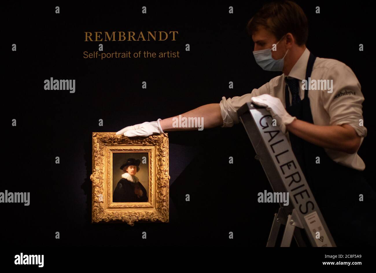 Gallery assistants in front of Self-portrait, wearing a ruff and black ...