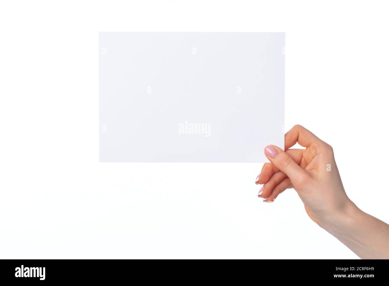 Female hand holding blank white sheet of paper isolated on white Stock ...