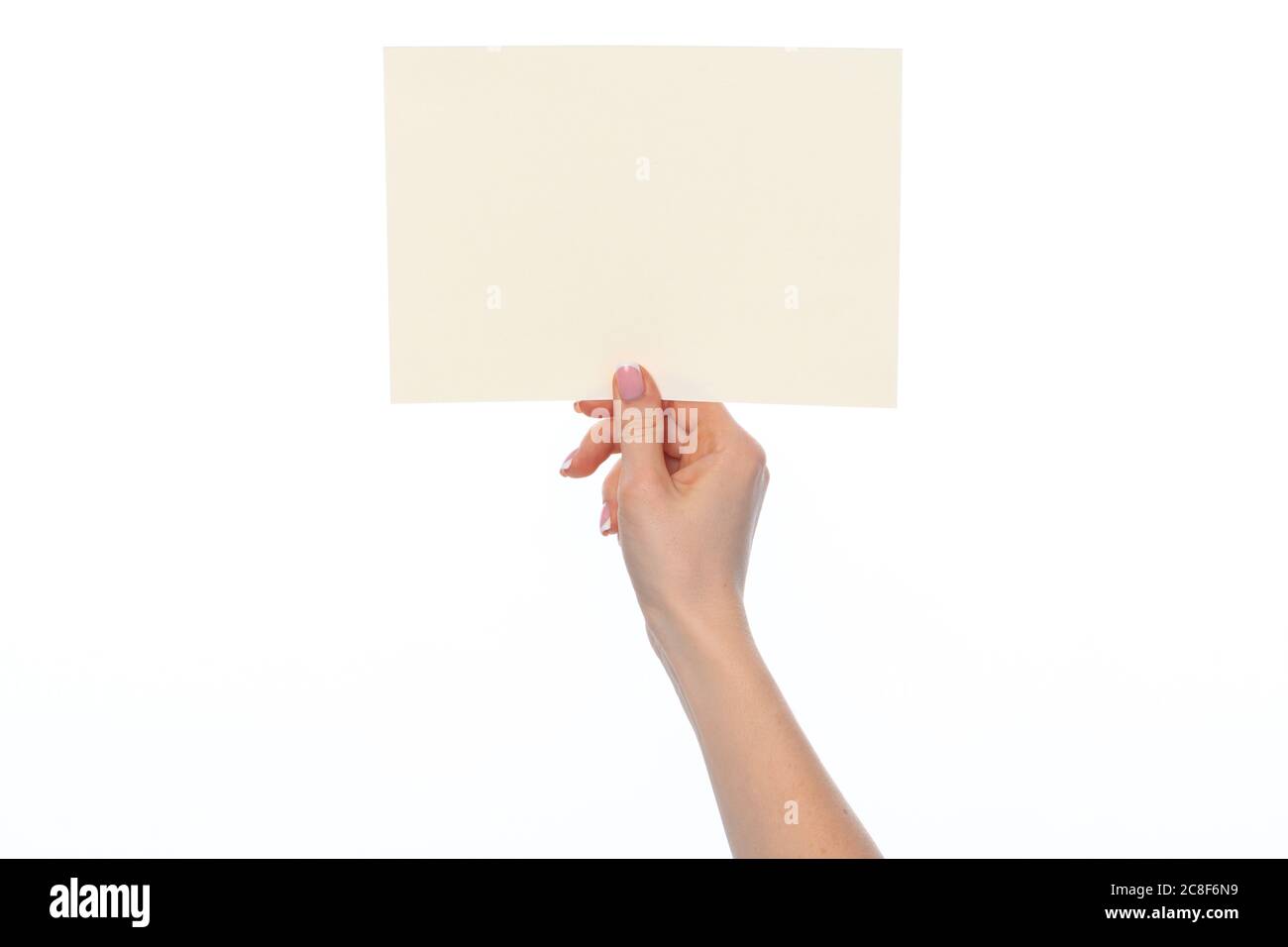 Female hand holding blank white sheet of paper isolated on white Stock ...