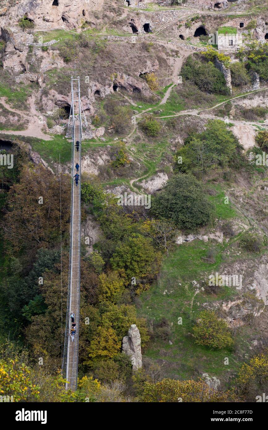 The cave village of Khndzoresk is connected by a suspension bridge that ...