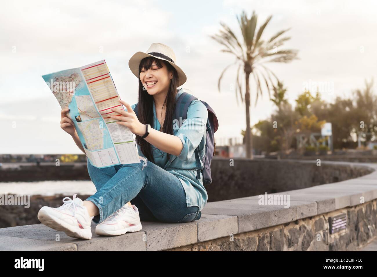 Travel Asian girl looking map during city tour - Young happy woman ...
