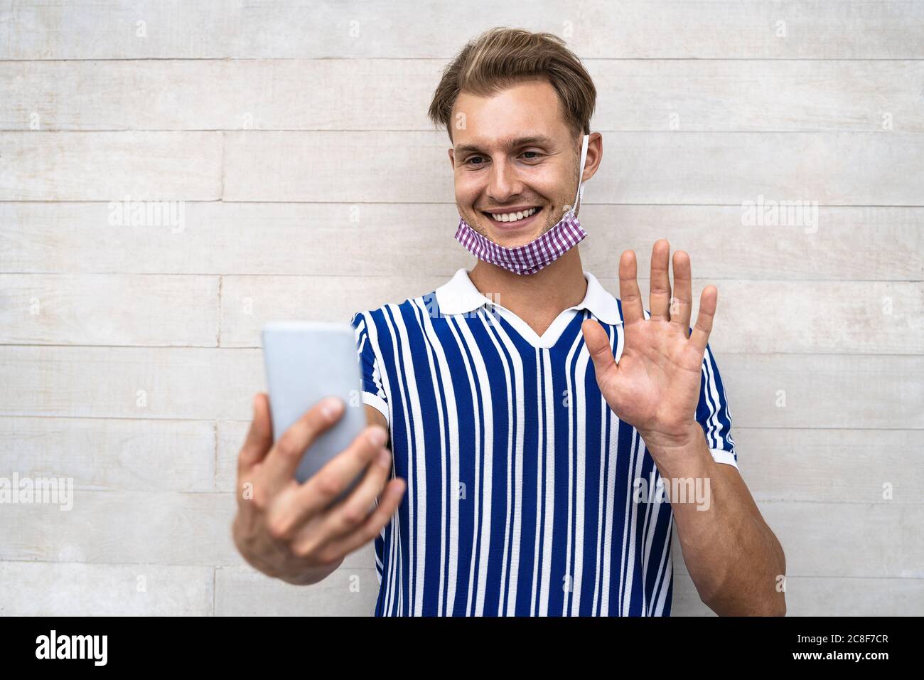 Young man video calling with mobile smartphone app - Happy guy having ...