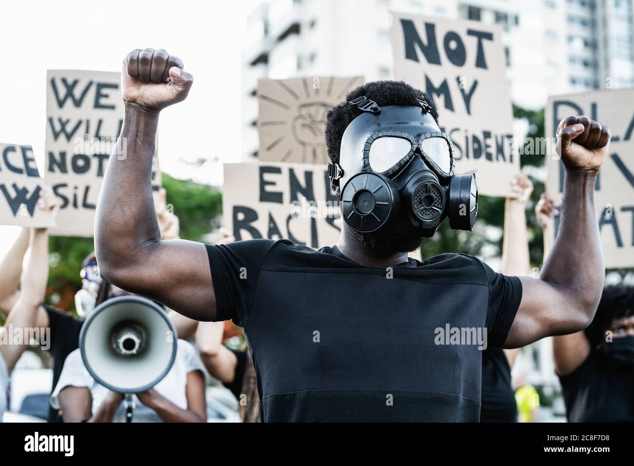 Activist wearing gas mask protesting against racism and fighting for ...