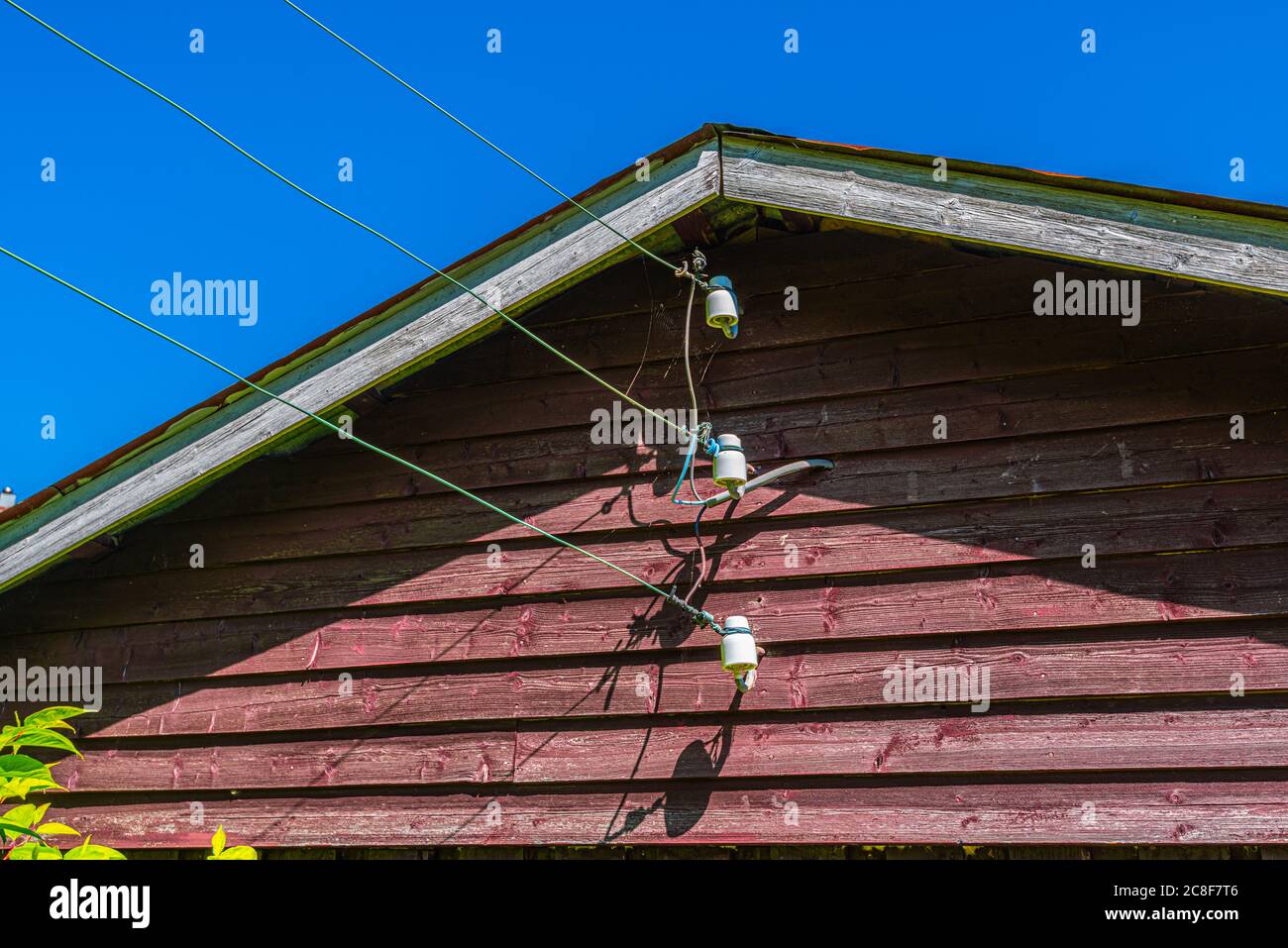 Old power lines connecting to the side of an old wooden house Stock ...