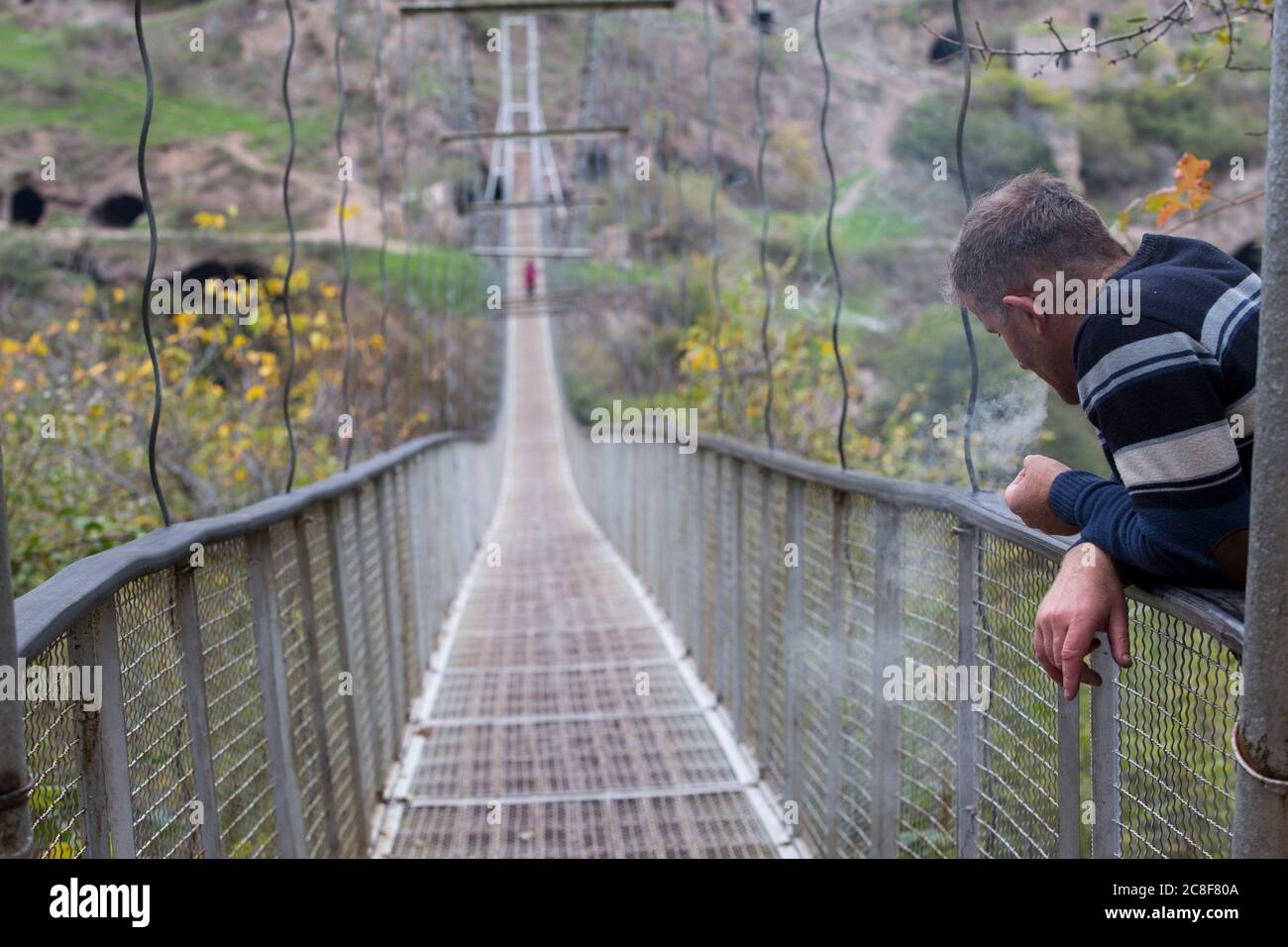 The cave village of Khndzoresk is connected by a suspension bridge that ...