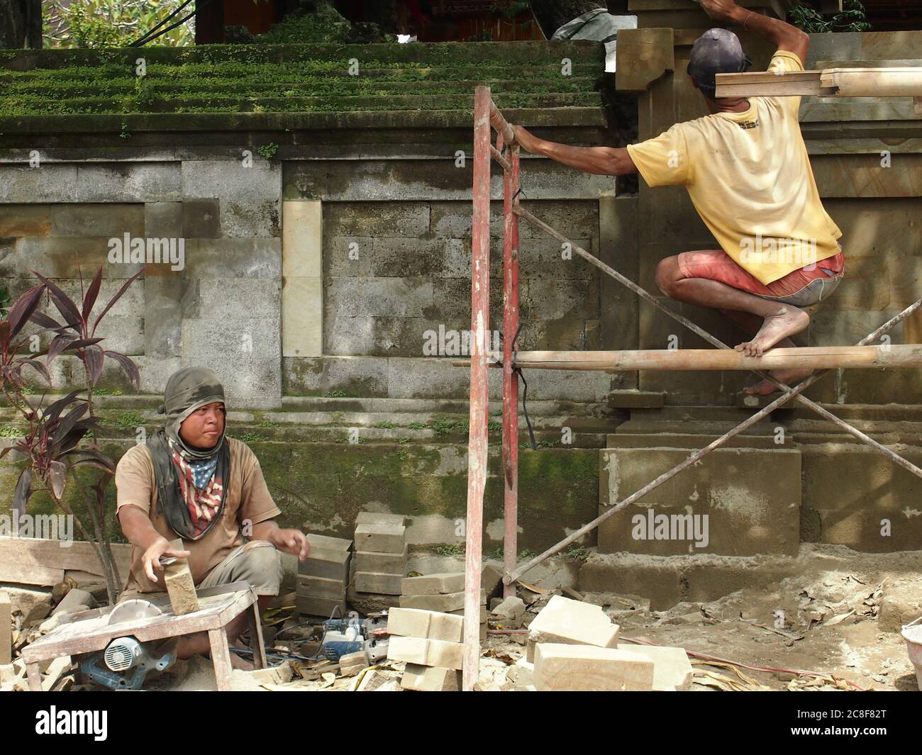 Construction workers repairing temple buildings, Batuan Temple, Pura ...