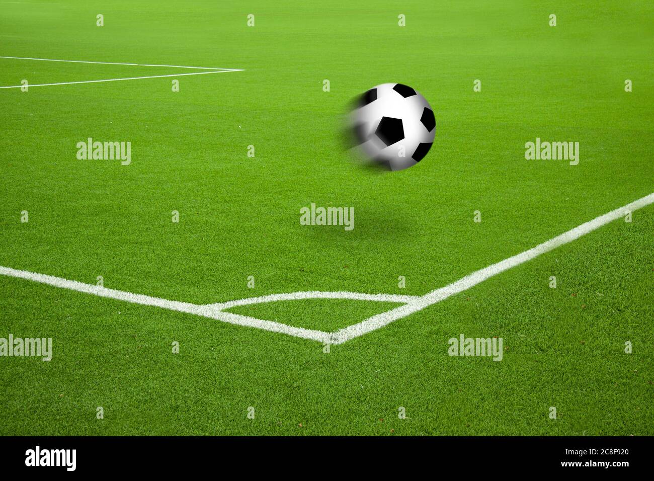Football in motion on soccer court with white stripes corner markings ...