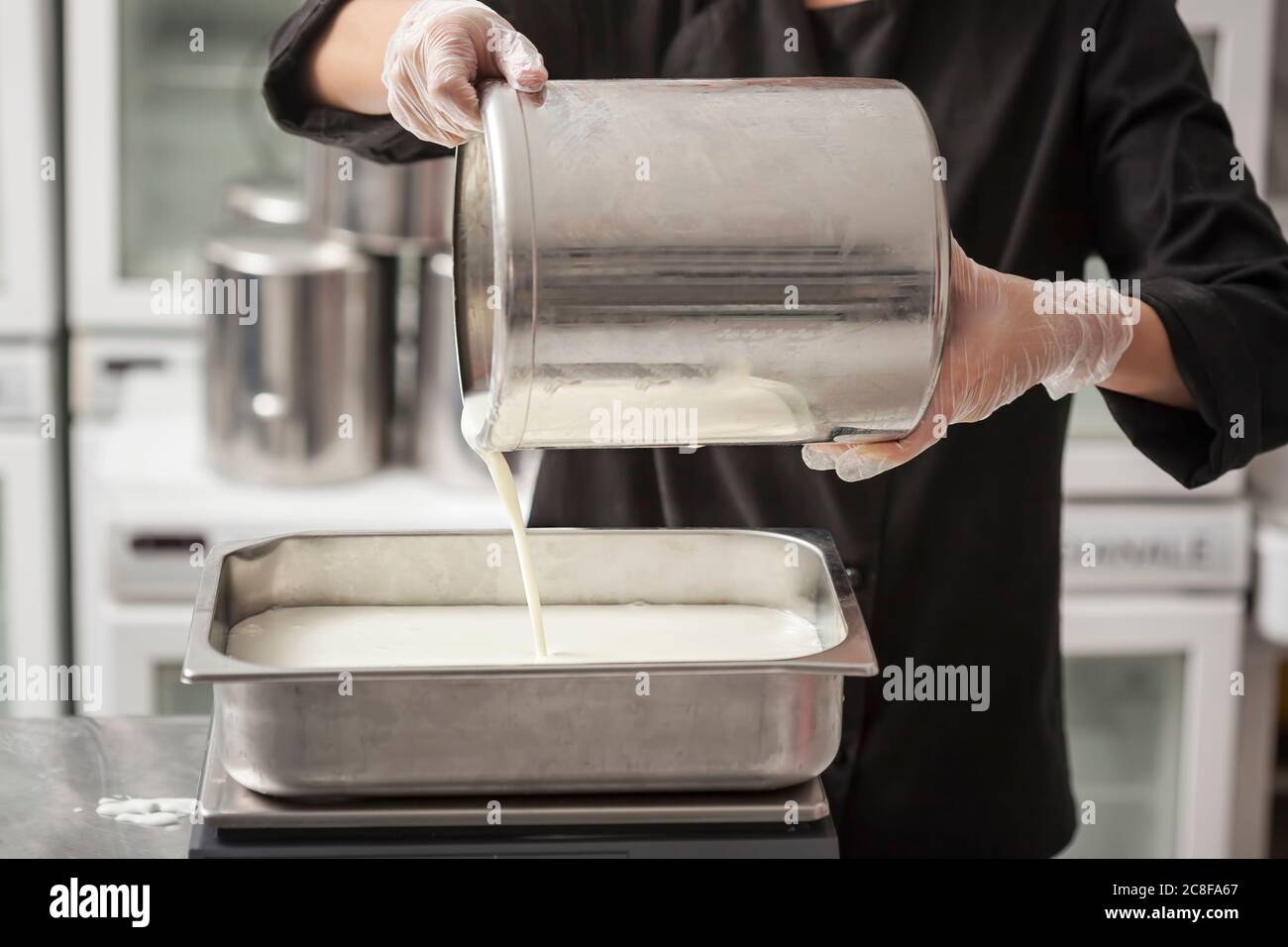 Chef with a jar filling condensed milk, making ice cream in the ...