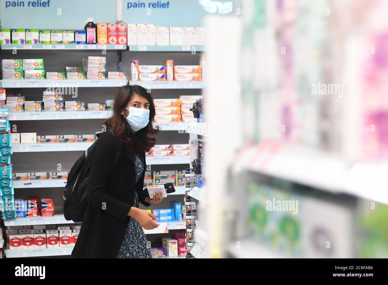 A shopper wearing a face mask in Boots on Oxford Street, London, as ...