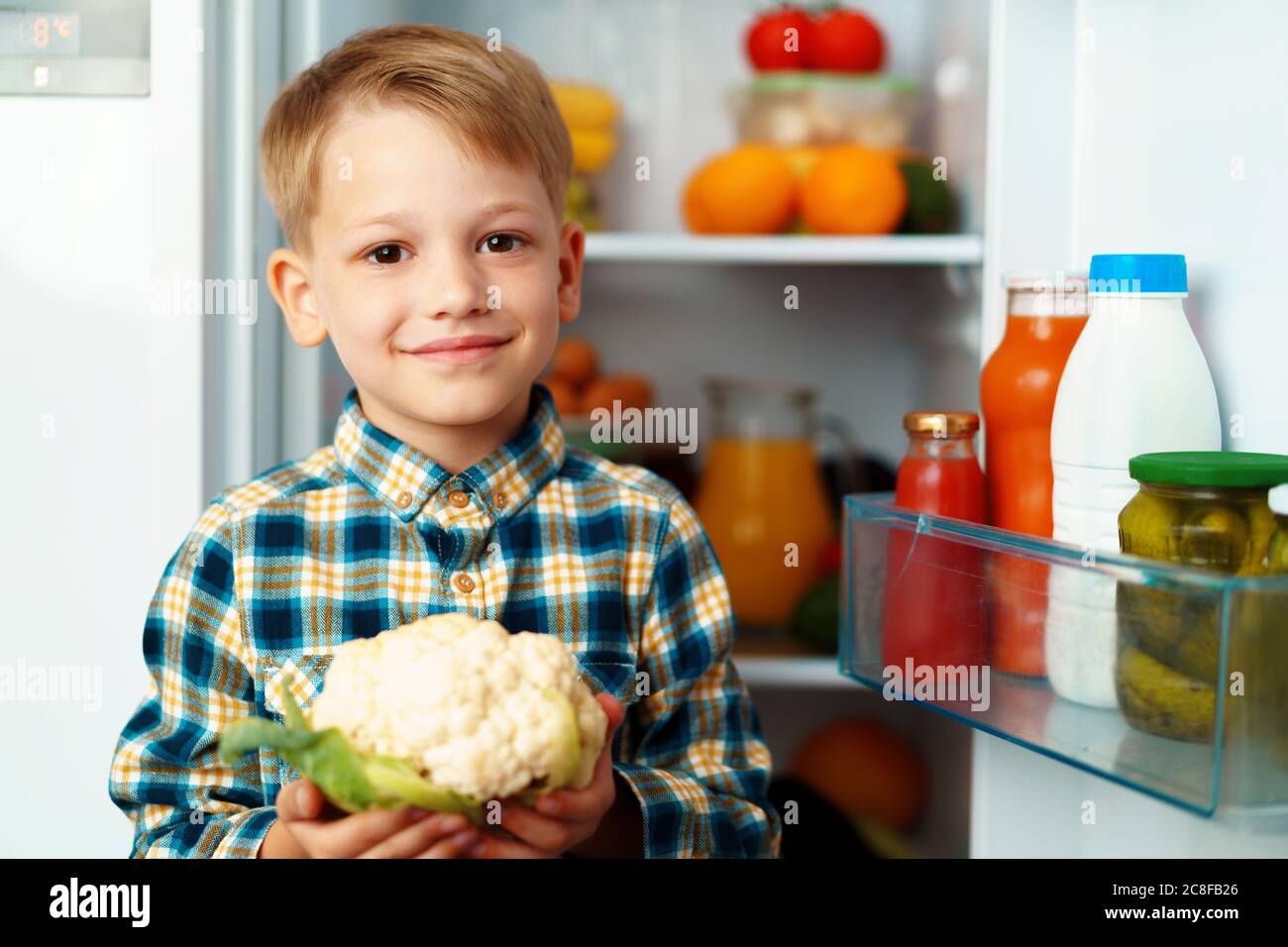 Boy standing in front of open fridge hi-res stock photography and ...