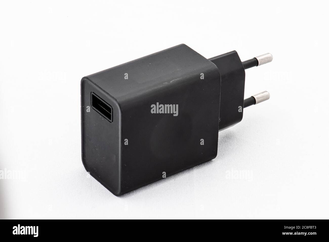 Black USB power adaptor on white background Stock Photo - Alamy