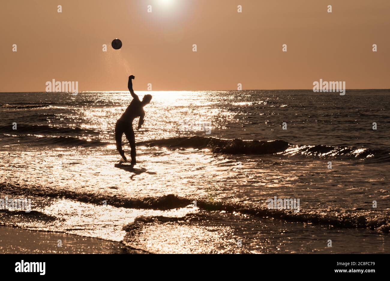 Child throwing ball into water hi-res stock photography and images - Alamy