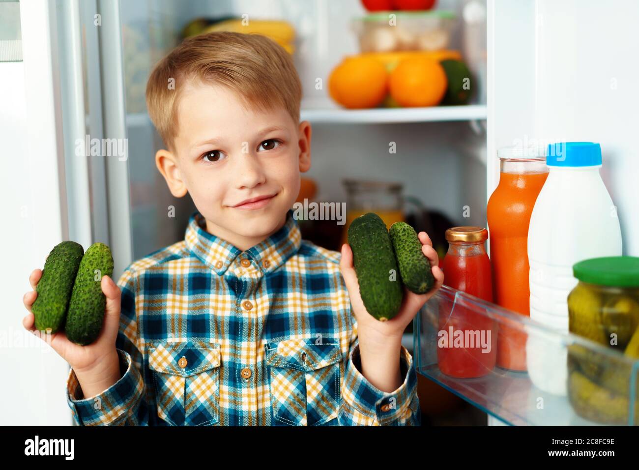 Boy standing in front of open fridge hi-res stock photography and ...