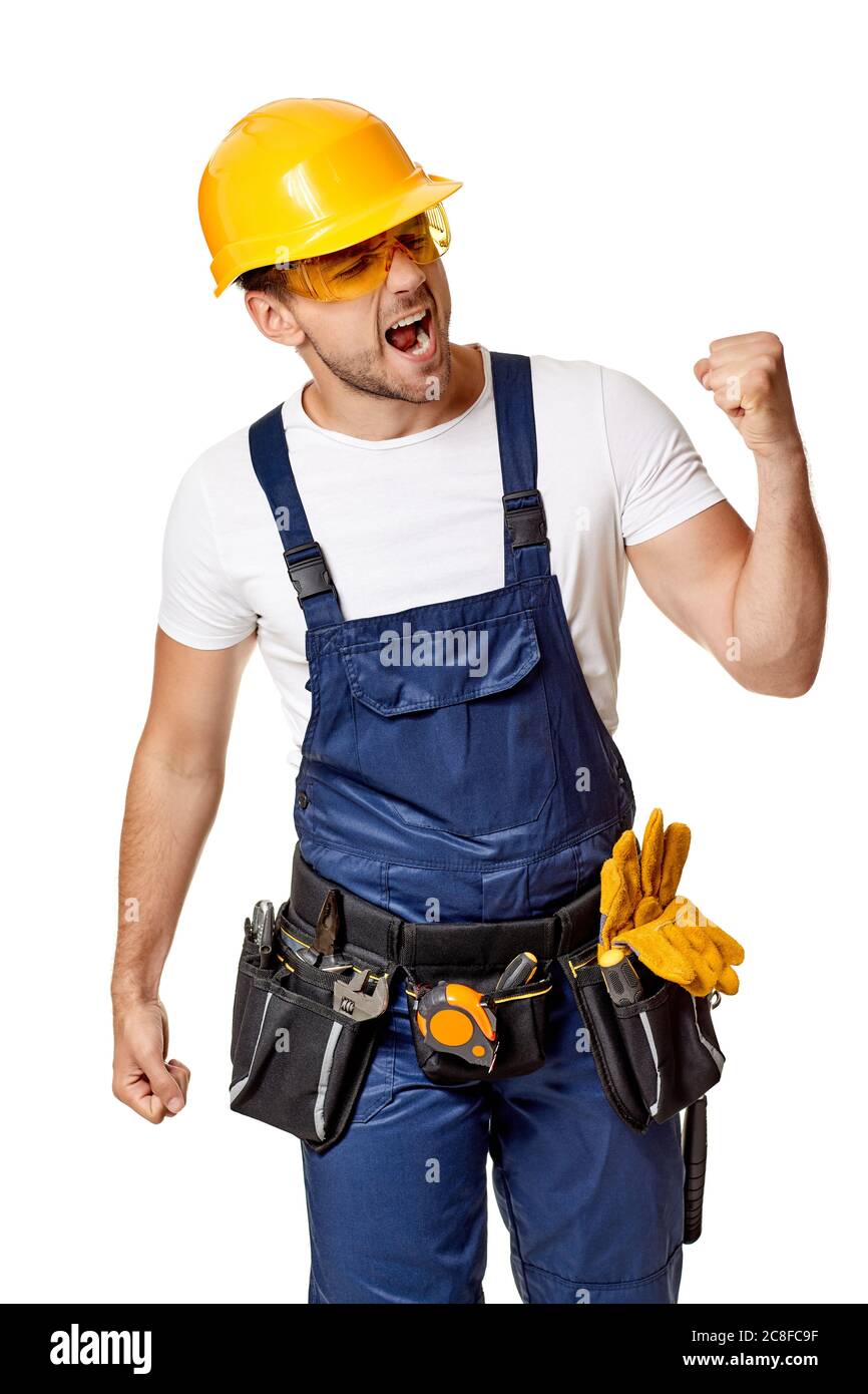 angry caucasian repairman worker in yellow hard hat and uniform ...