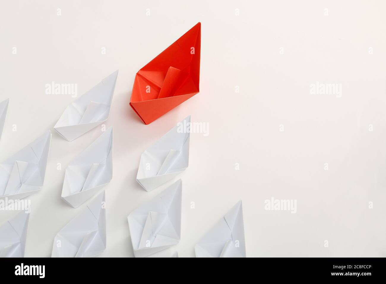 red paper boat leading white ones, leadership concept Stock Photo - Alamy