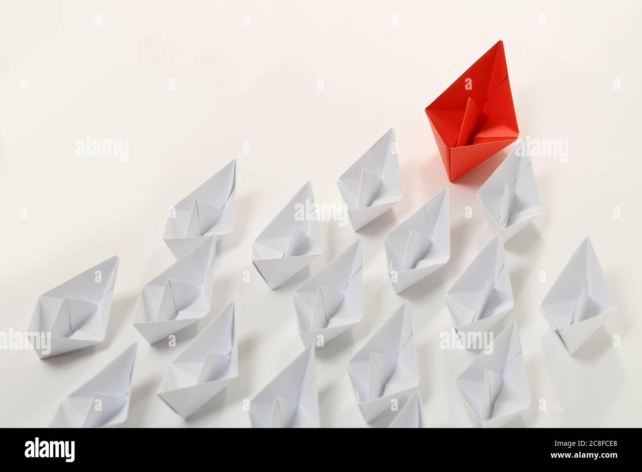 red paper boat leading white ones, leadership concept Stock Photo - Alamy