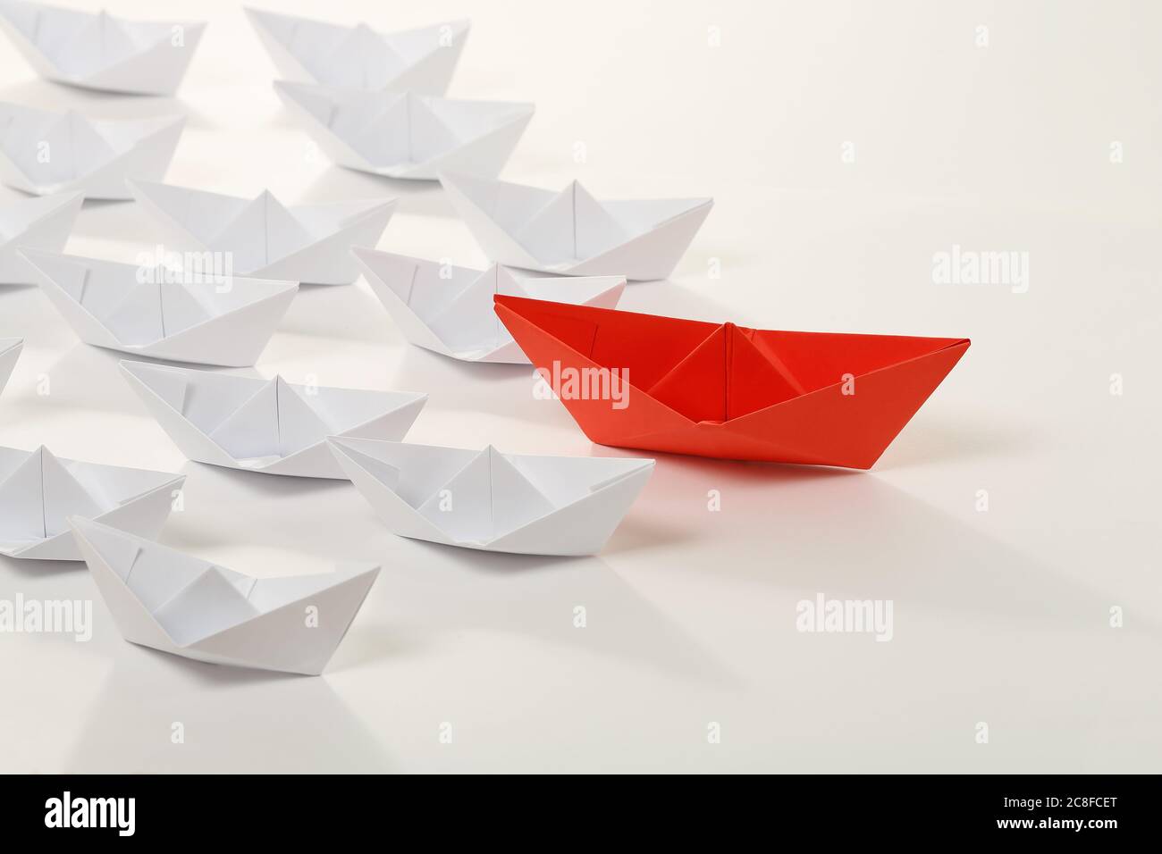 red paper boat leading white ones, leadership concept Stock Photo - Alamy